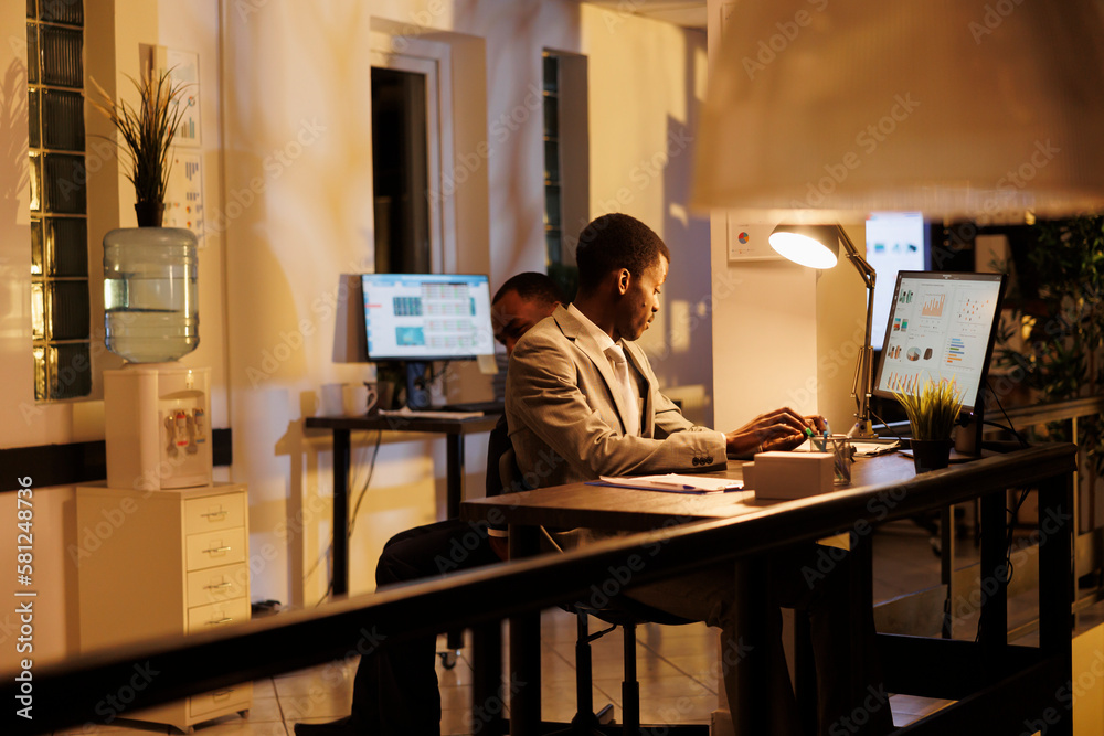 Corporate employee working late at night at marketing strategy ...