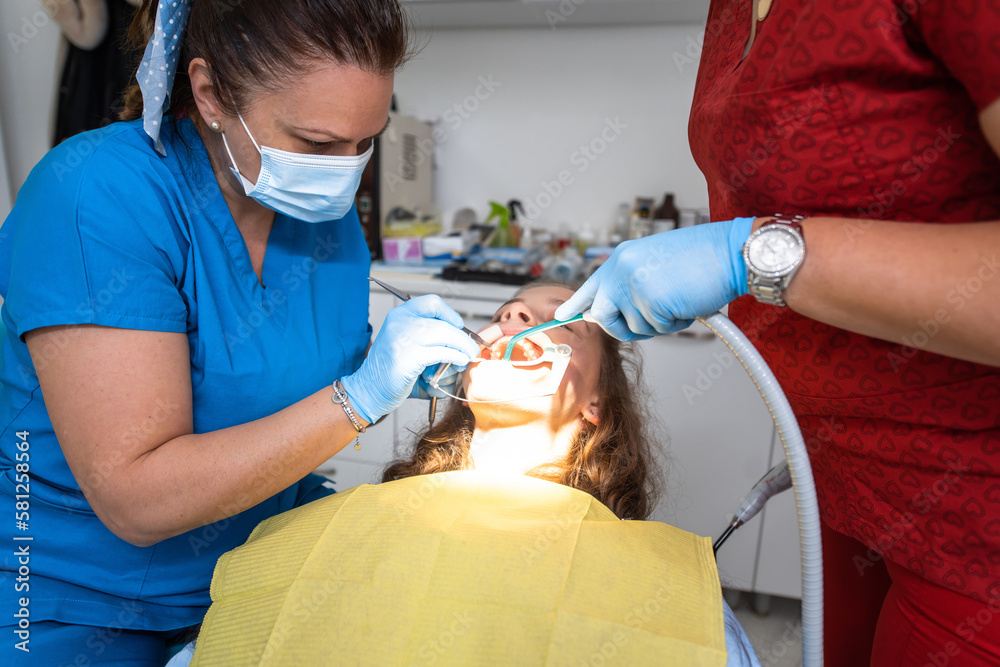Dentist appointment at a dental clinic, placing braces locks on the ...