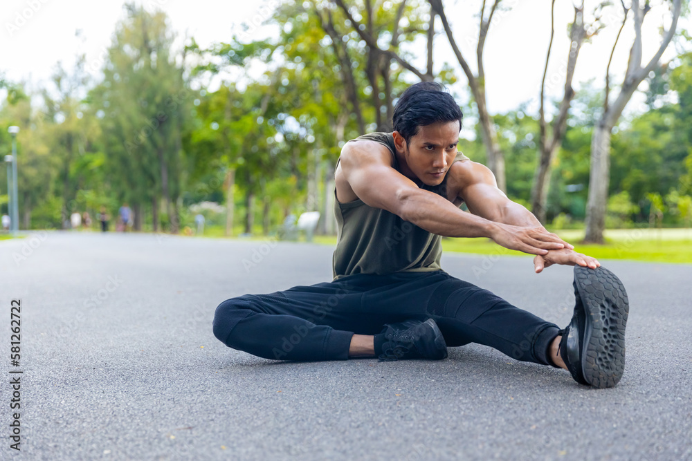 Asian man in sportswear stretching body and warm up before jogging ...