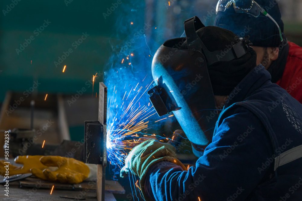 The welder is welding a structural steel with gas metal arc welding ...