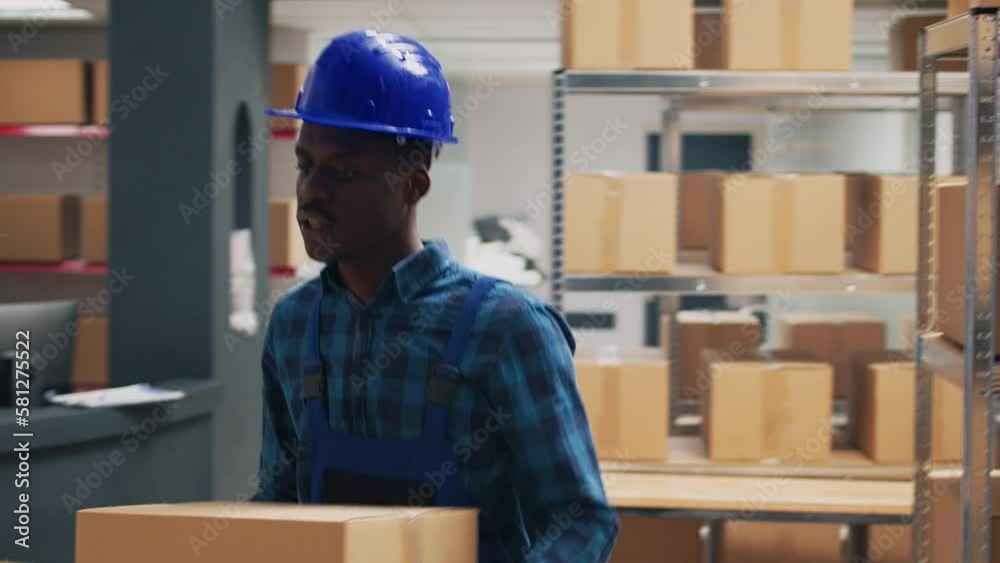 African american man bringing box of goods to manager to scan barcodes ...