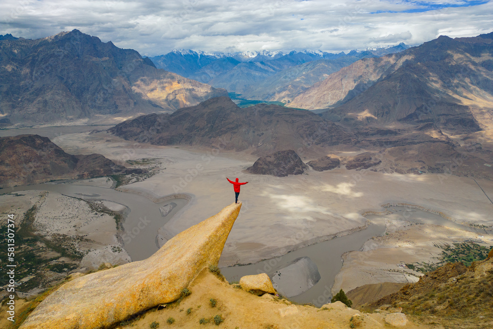 A tourist man climbing Marsur Rock cliff in Karakoram high mountain ...