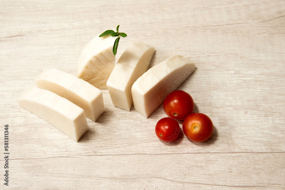 Majorero cheese on the kitchen table with cherry tomatoes. Made with ...