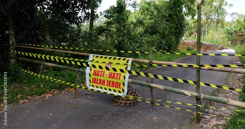 Text on sign says 'Caution, road damaged', yellow banner on custom ...