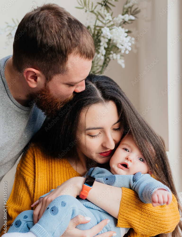 Family with baby boy sitting on the bed with cute dog. Mother and ...