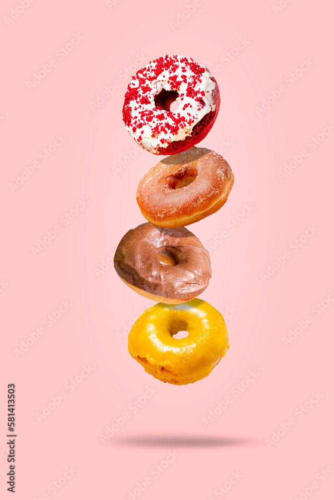 Levitating donuts isolated on a pink background. Modern food concept ...
