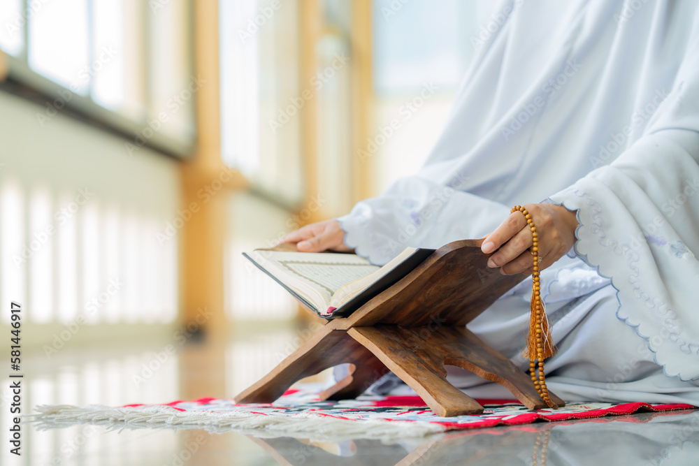 Portrait Asian Muslim woman reading the Quran and appreciating and ...