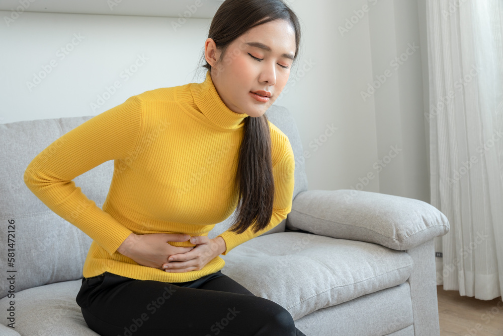 Naklejka stomach ache. Asian women have abdominal pain, indigestion ...