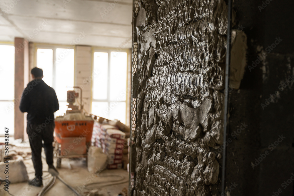 Construction worker wearing worker overall with wall plastering tools ...