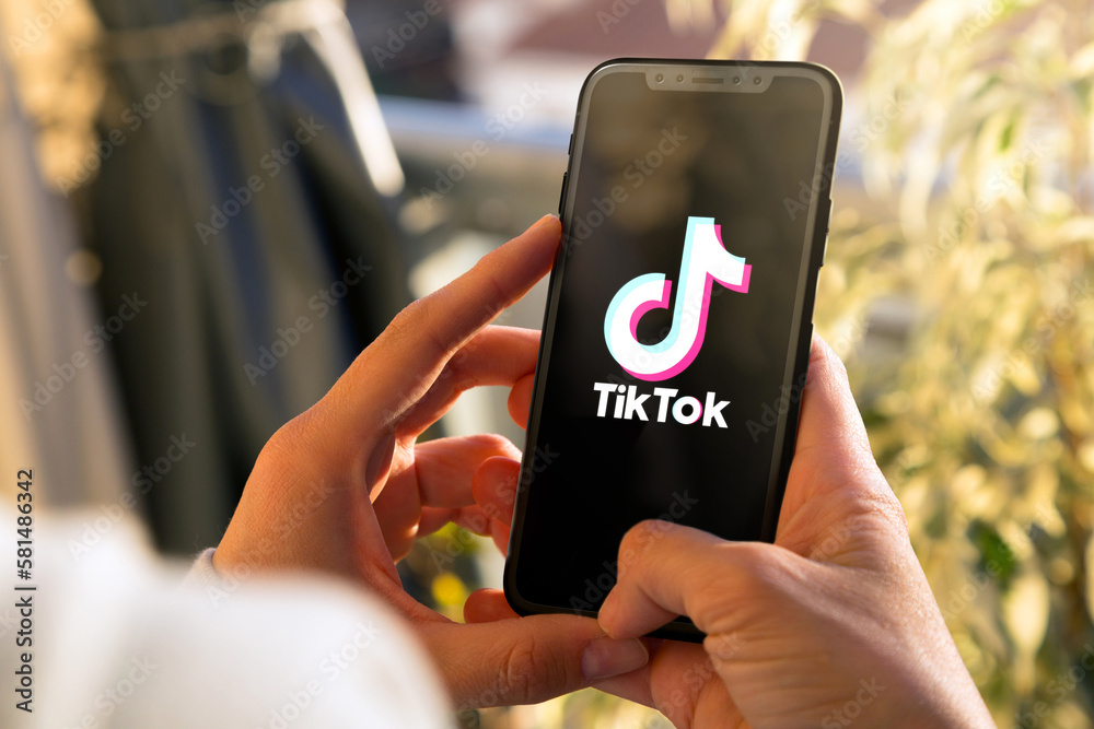 Foto de Tiktok on mobile phone Screen. Young woman holding a Smart ...