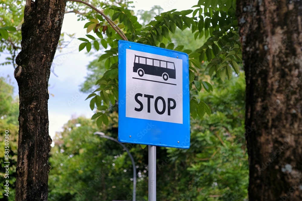 Stop sign for bus public transport on roadside. Stock Photo | Adobe Stock