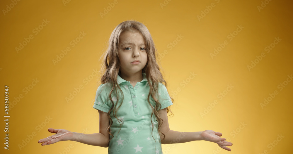 Little caucasian girl shruging and throwing her arms wide in ...