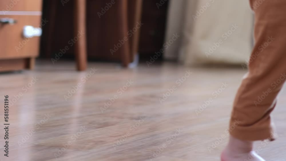 Little charming children's feet stomp on the chair. Baby in denim pants ...