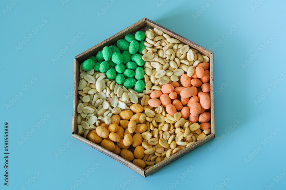 Six varieties of multi-colored roasted glazed peanuts in a hexagonal ...