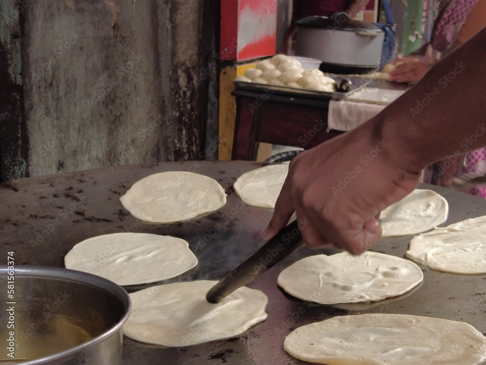 cooking roti chapati on a big cooking pan Stock Photo | Adobe Stock
