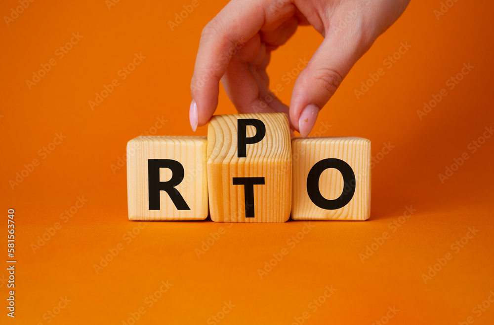 RPO vs RTO symbol. Businessman hand turns wooden cubes and changes the ...