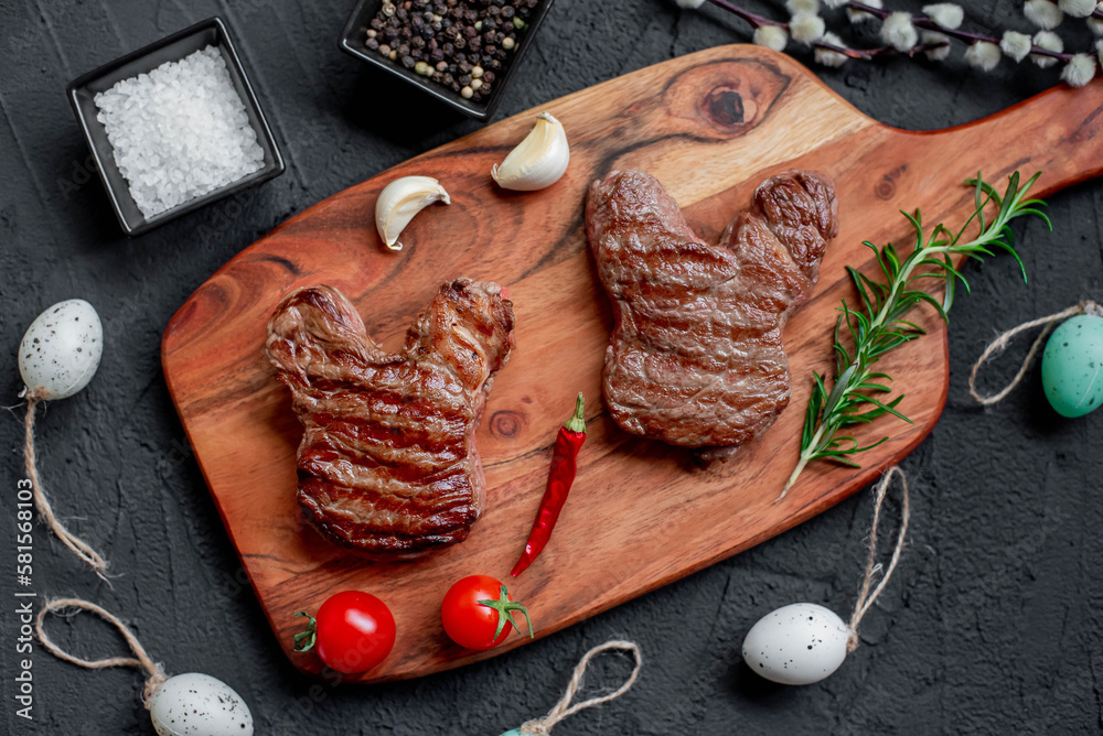Easter grilled beef steaks in the shape of a rabbit on a stone ...