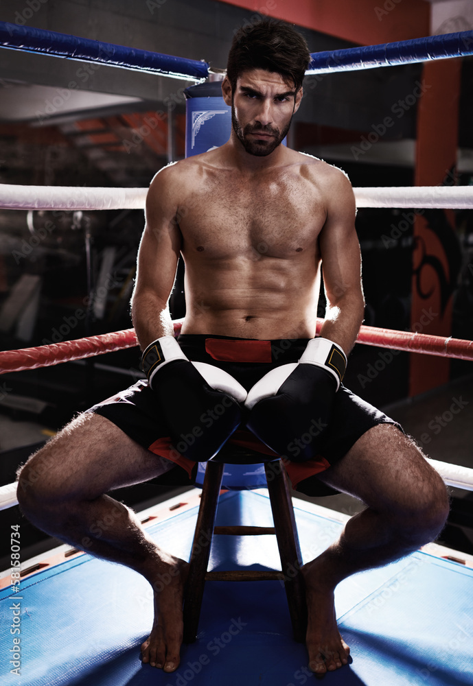Victor in the corner. A determined bare-chested boxer sitting in the ...
