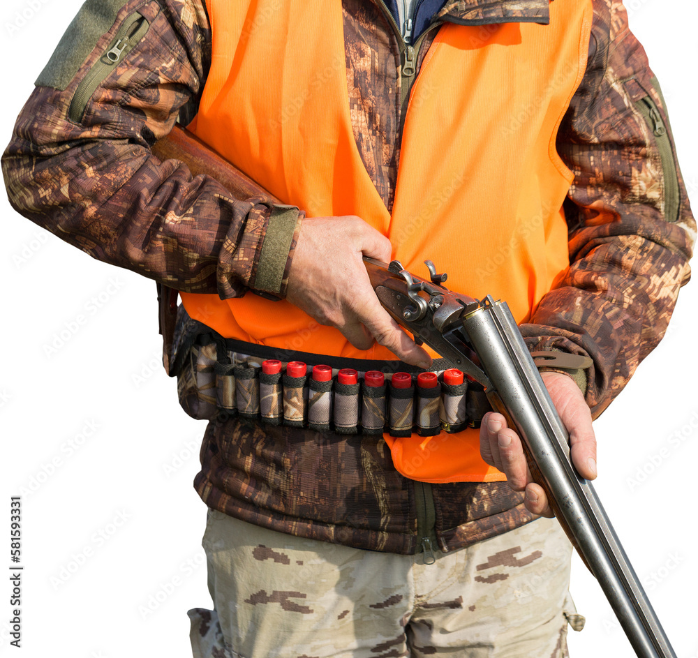 A hunter with a gun in his hands in hunting clothes in the autumn ...