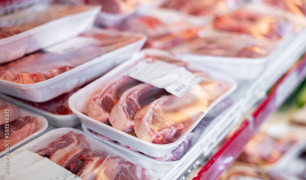 Packaged mutton meat displayed on shelves of animal products section of ...