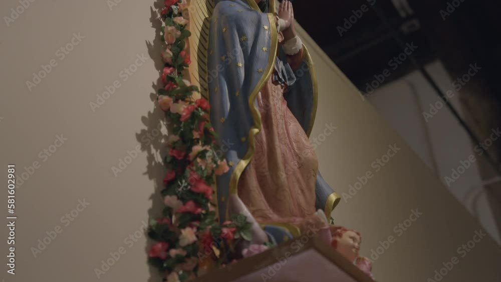 This panning video shows a side view of a beautiful Virgin Mary statue ...