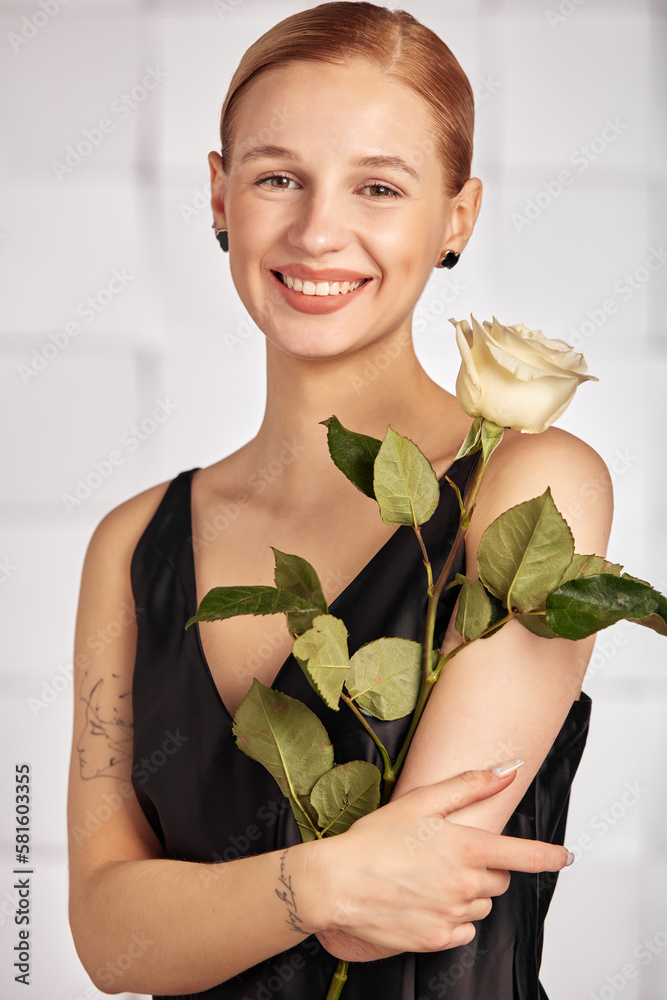 Beautiful young with special needs woman with flowers in her hand ...