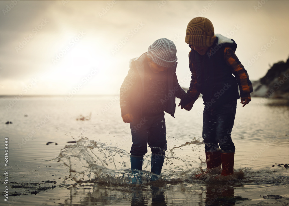 Beach, sunset and silhouette of children in water splash together ...