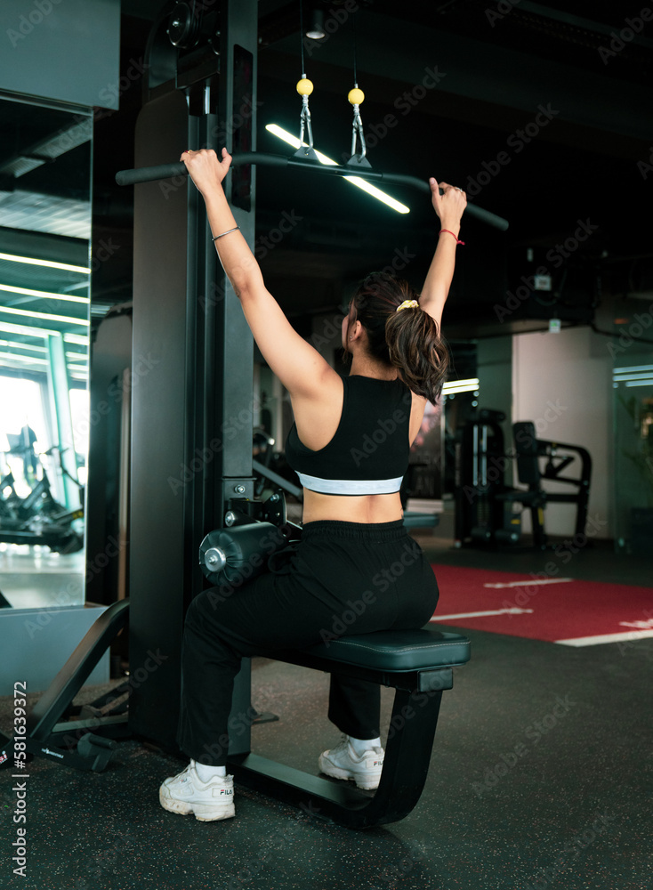 Lat Pull Down Exercise Done by Young Indian Fit Gym Girl for Lower and ...