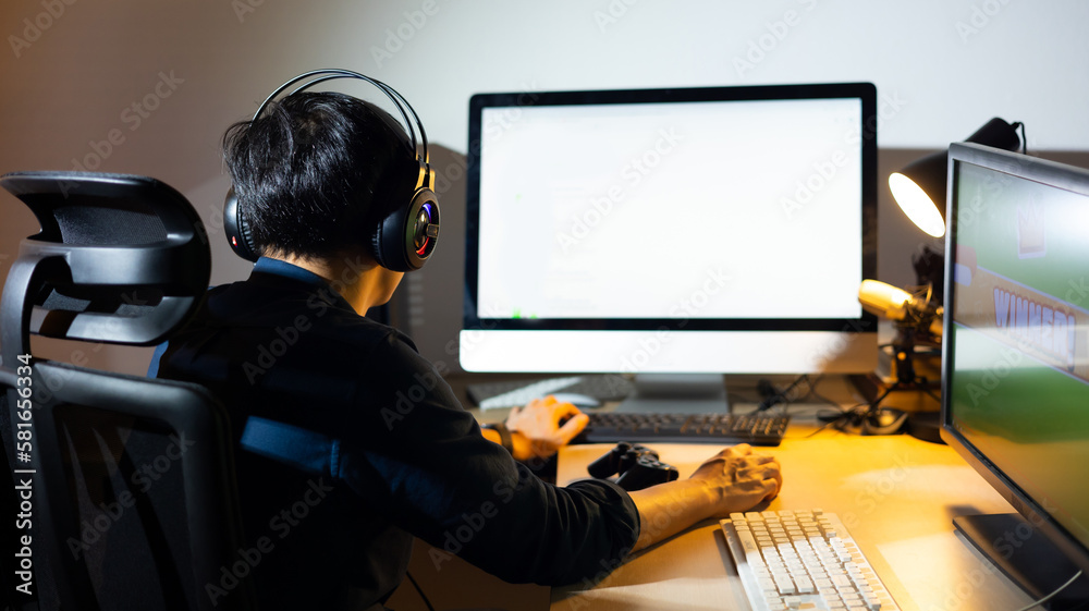 Back view. Happy Professional Asian male gamer playing video games on ...