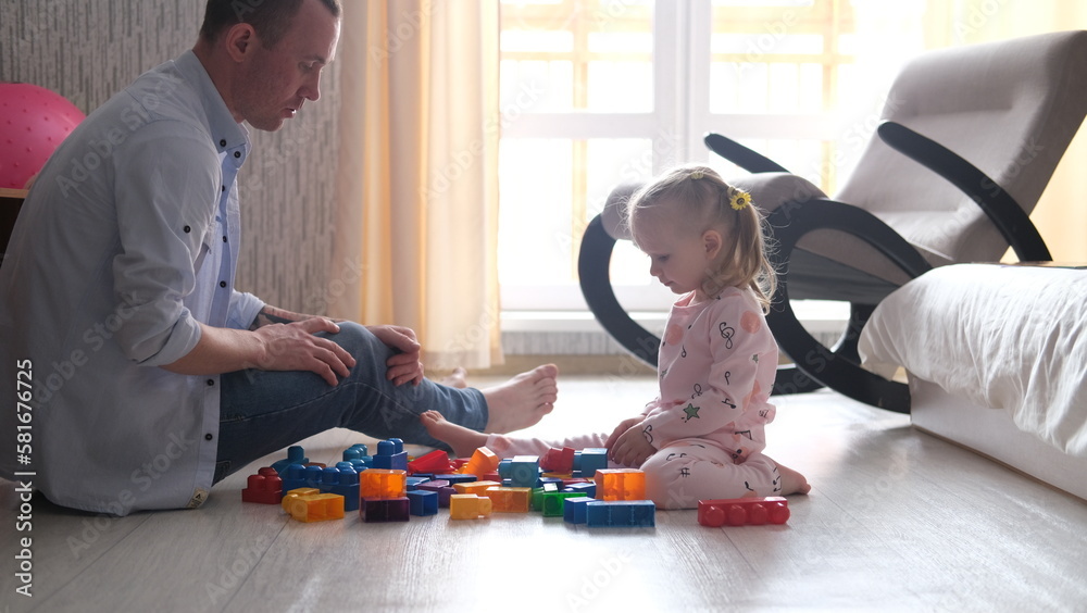 Dad and daughter are building family home. Happy family. Educational ...