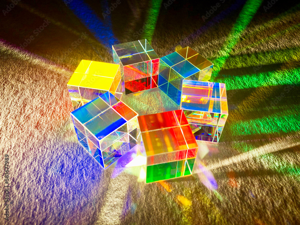 Cubic coloured dichroic glass disperse narrow beam of artificial light ...