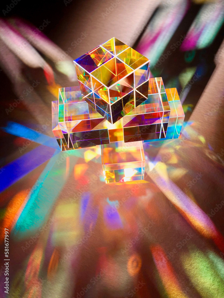 Cubic coloured dichroic glass disperse narrow beam of artificial light ...