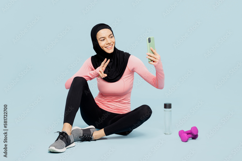 Full body young fitness trainer sporty woman wear pink abaya hijab ...