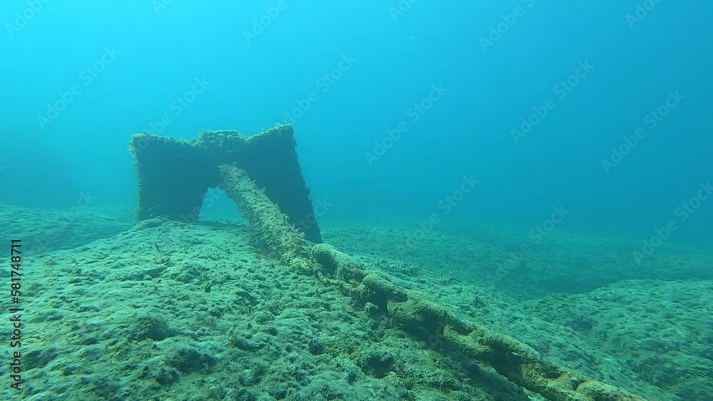 Anchor chain and anchor on the seabed. An anchor chain covered with ...