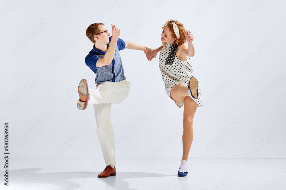 Beautiful young couple, man and woman in stylish retro costumes dancing ...