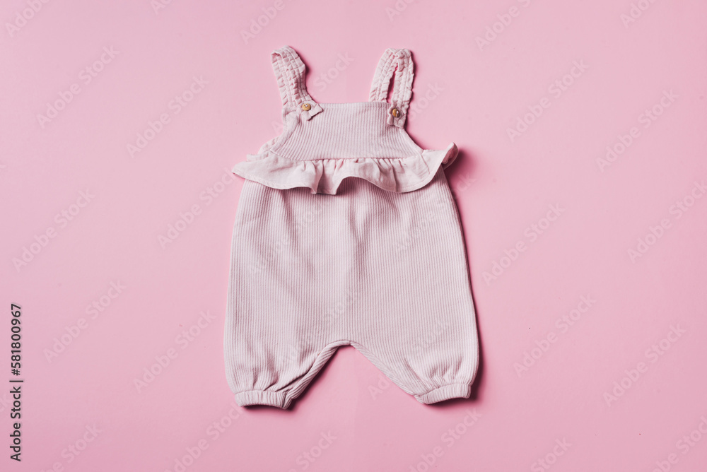Pink baby girl romper on pastel backgroundd. Set of baby clothes and ...