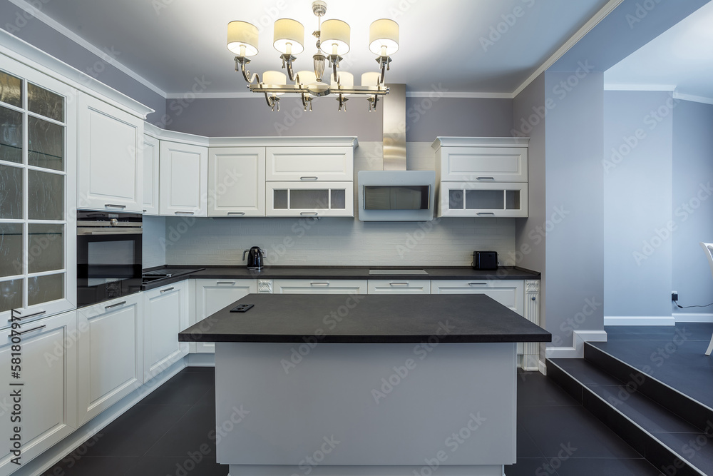 Fashionable kitchen with grey walls and white furniture, a kitchen in a ...