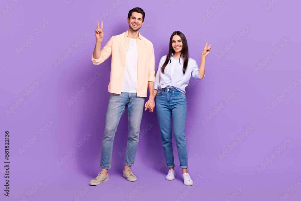Full body portrait of two cheerful partners hold arms demonstrate v ...