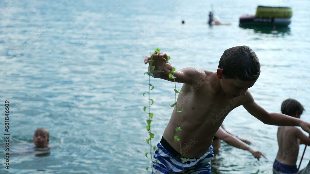 Children enjoying lake water during summer vacations. People bathing ...