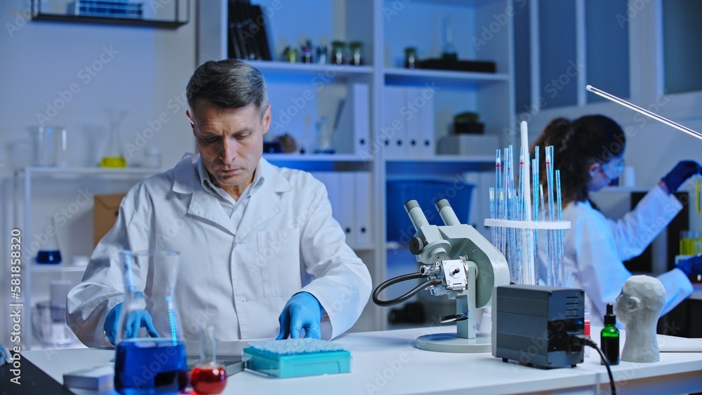 Forensic lab technicians analyzing crime scene samples, checking ...