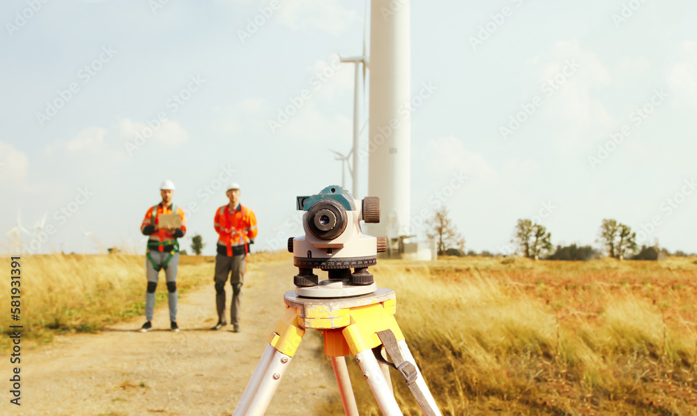 Architect male surveyor team working with surveyor's telescope to ...