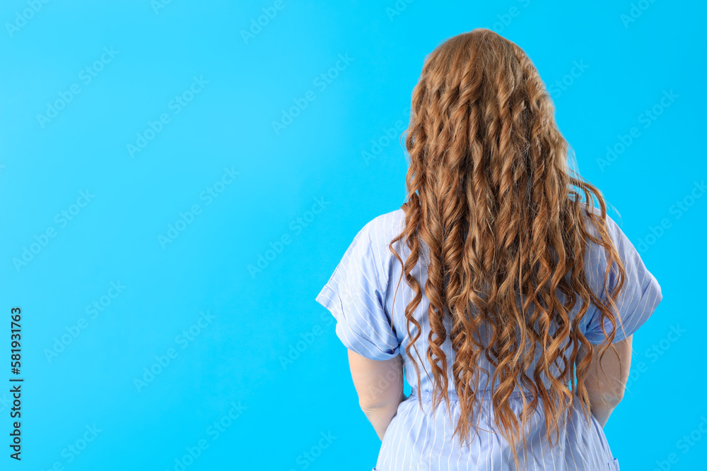 Beautiful woman with red hair on blue background, back view Stock Photo ...