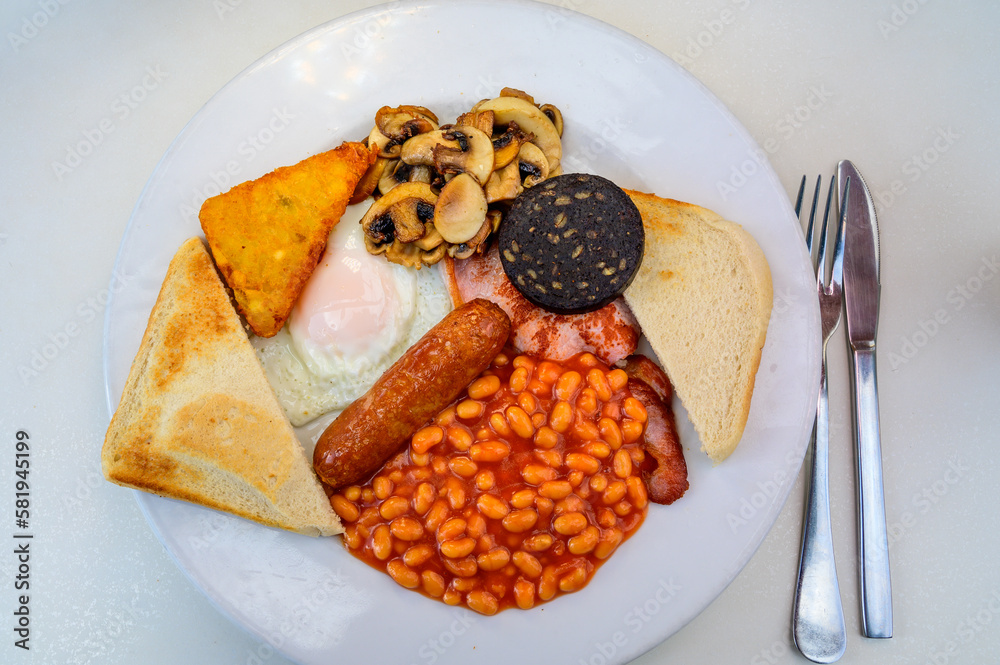 White board with full English breakfast with bacon, fried egg, beans ...