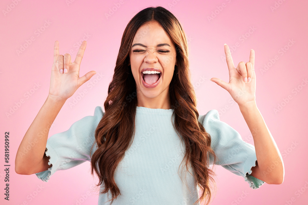Portrait of woman, rock hand gesture and excited expression in studio ...