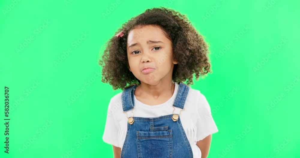 Sad, unhappy and face of a child on a green screen isolated on a studio ...