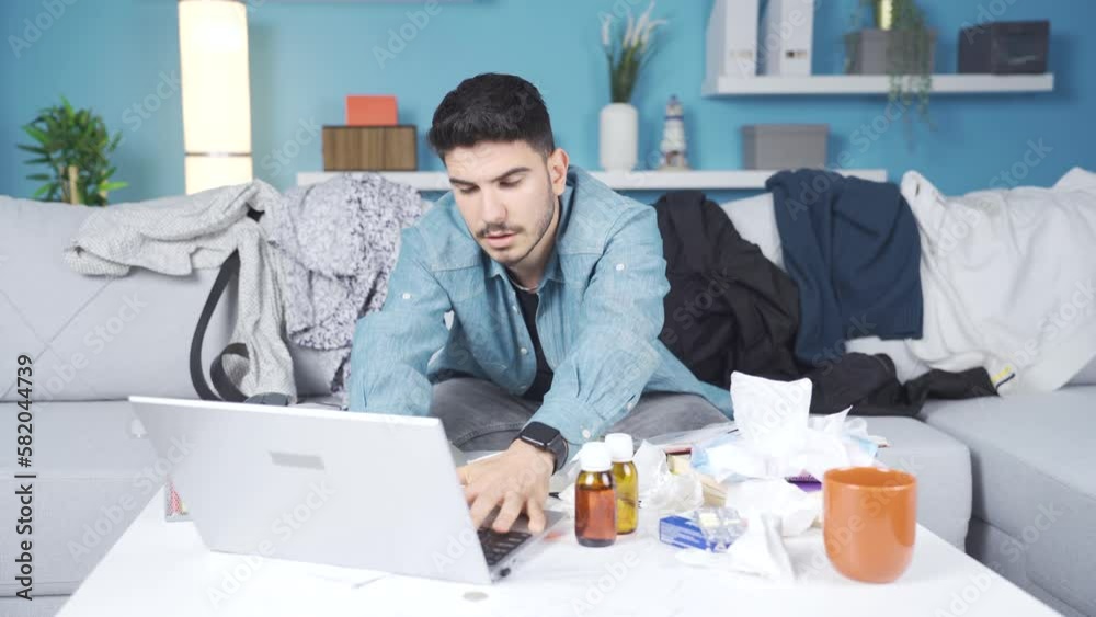 Sick young man works from home, his condition is not good. Young man ...