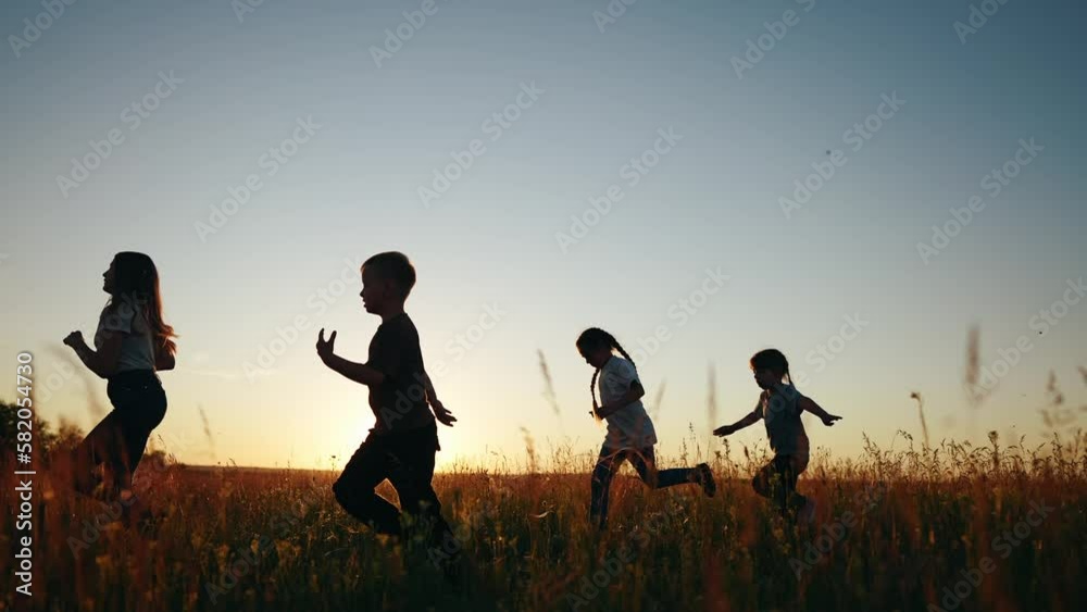Children running in park at sunset. happy family kindergarten kids ...