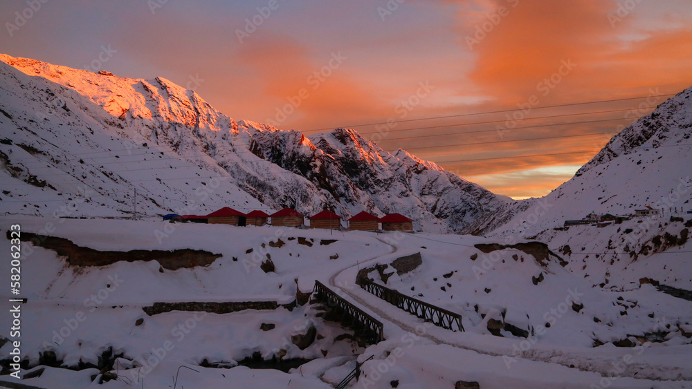 Snow covered mountain, sun rays in Himalayan state Uttarakhand. Dotted ...