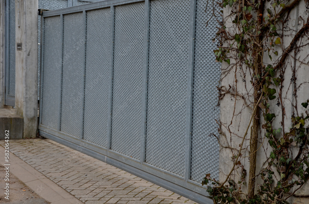 entrance to the yard to the parking lot through a low sliding gate. the ...