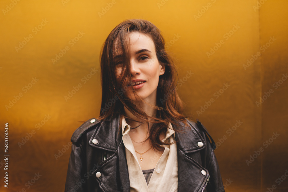 Simpering young brunette woman with a coy smile as she flirts over a ...